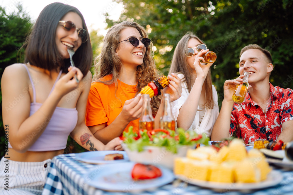 Group of young happy friends having picnic outdoors. People having fun ...