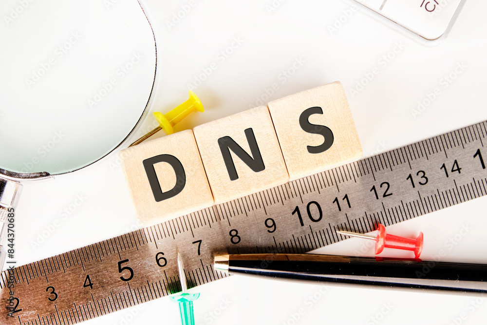DNS word word is made up of wooden cubes on a white background in a ...
