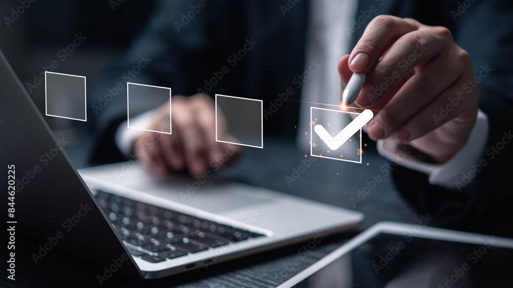 Businessperson completing digital checklist on laptop. Concept of ...