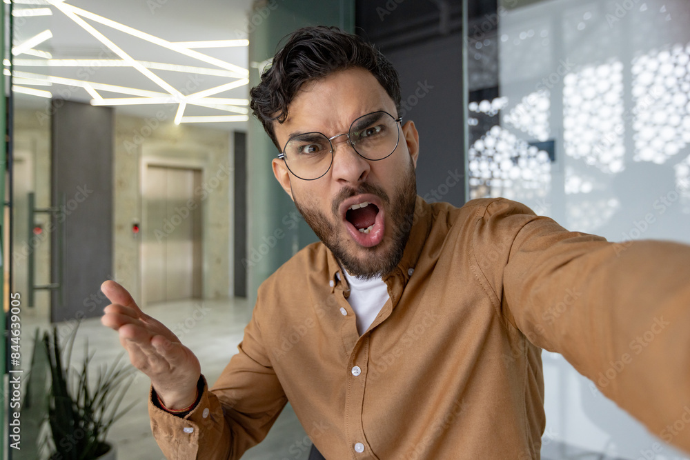 Close-up photo of an angry young Indian man in glasses who is in the ...