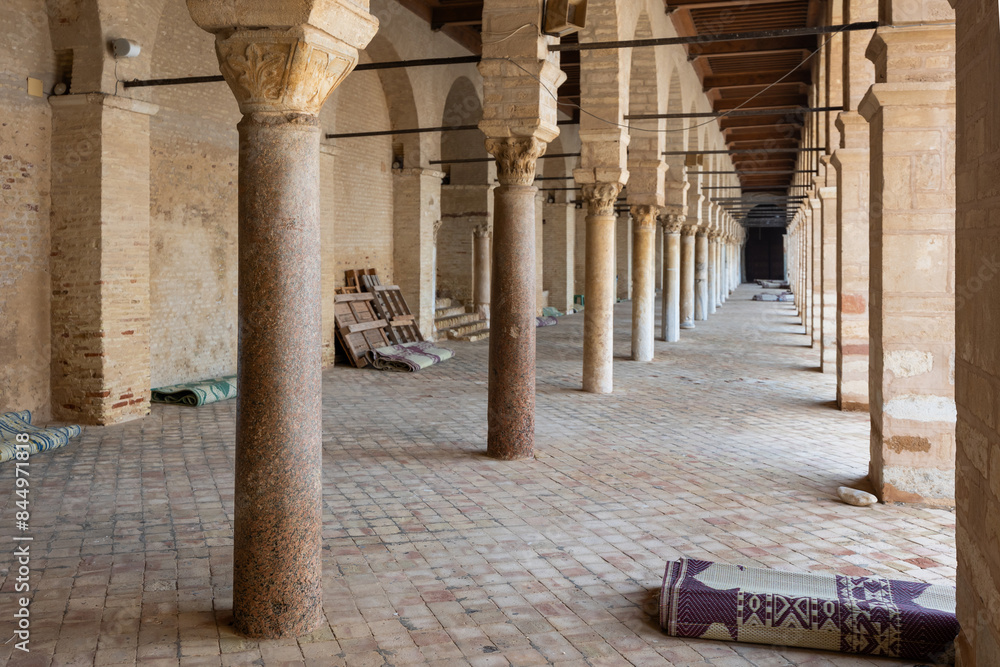 Corridor with arched stone colonnade encircling inner courtyard of ...