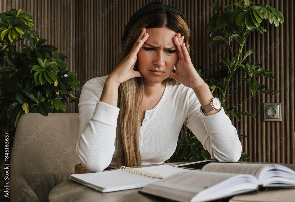 Woman feels work stress, holding head in frustration while surrounded ...