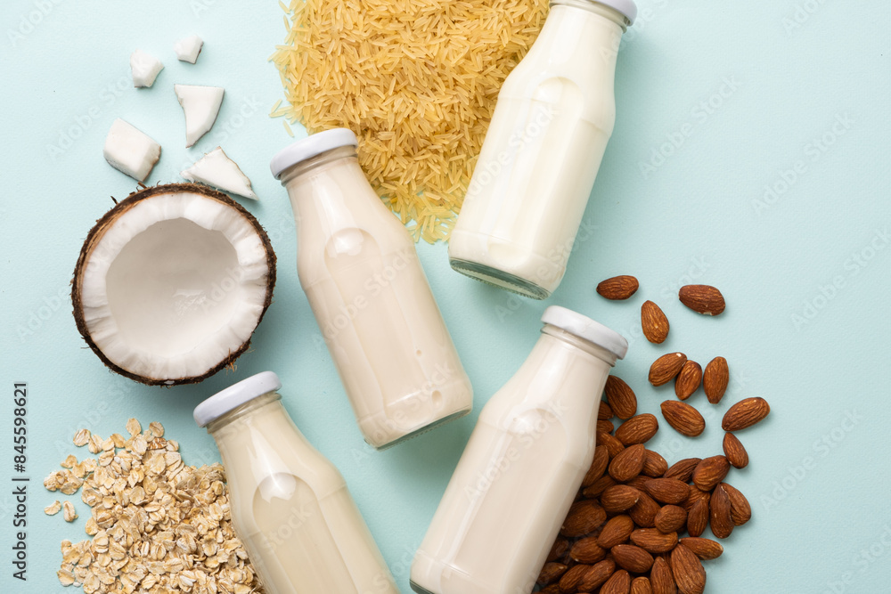 Types of plant-based milk in glass bottles. Coconut, rice, almond and ...