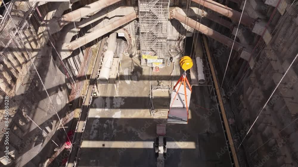 The TBM ring segments are lowered by a gantry crane and placed on the ...