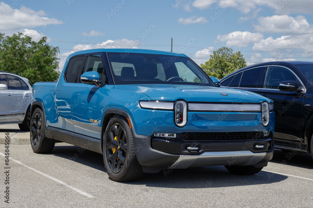 Rivian R1T EV pickup truck display. Rivian offers the R1T in Adventure ...