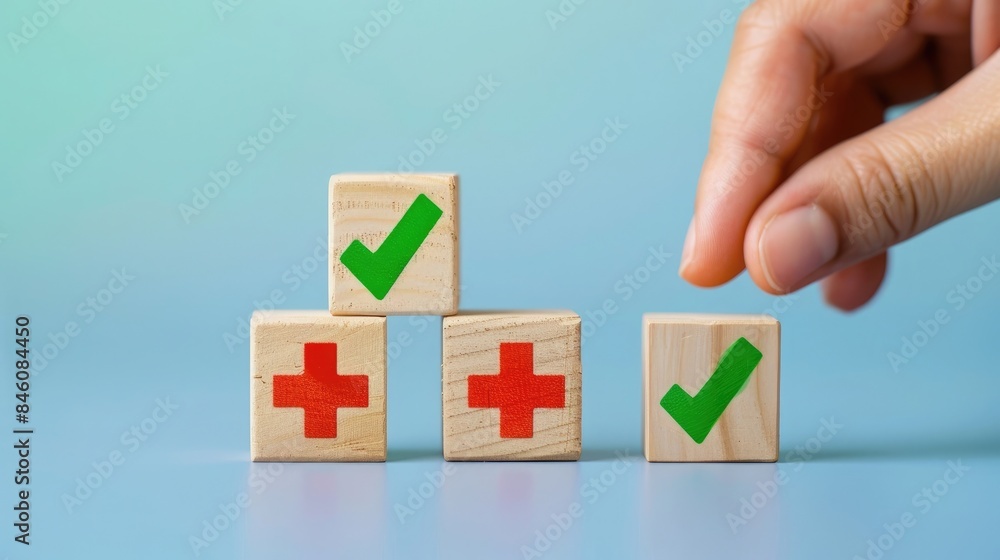 Hand placing green check mark top red cross cube wooden toy block with ...