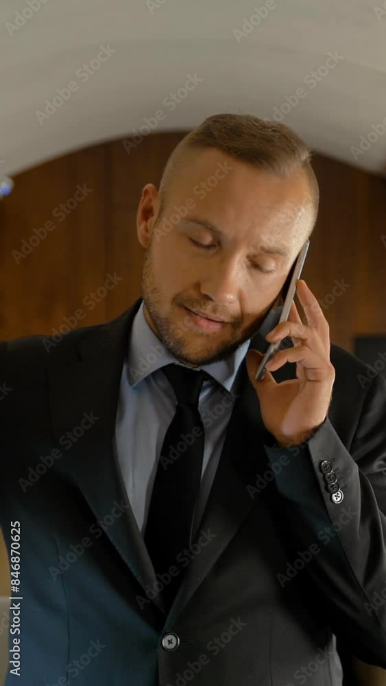 Entrepreneur talk on mobile phone while travel in private jet. Luxury ...