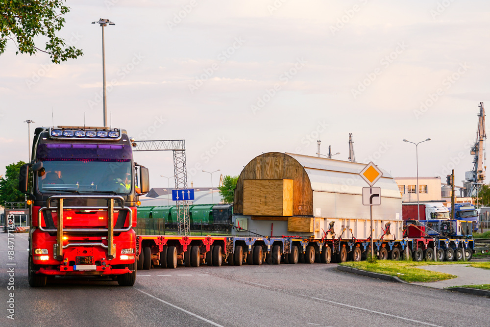 Truck with a specialized multi-axle trailer carries a very heavy ...