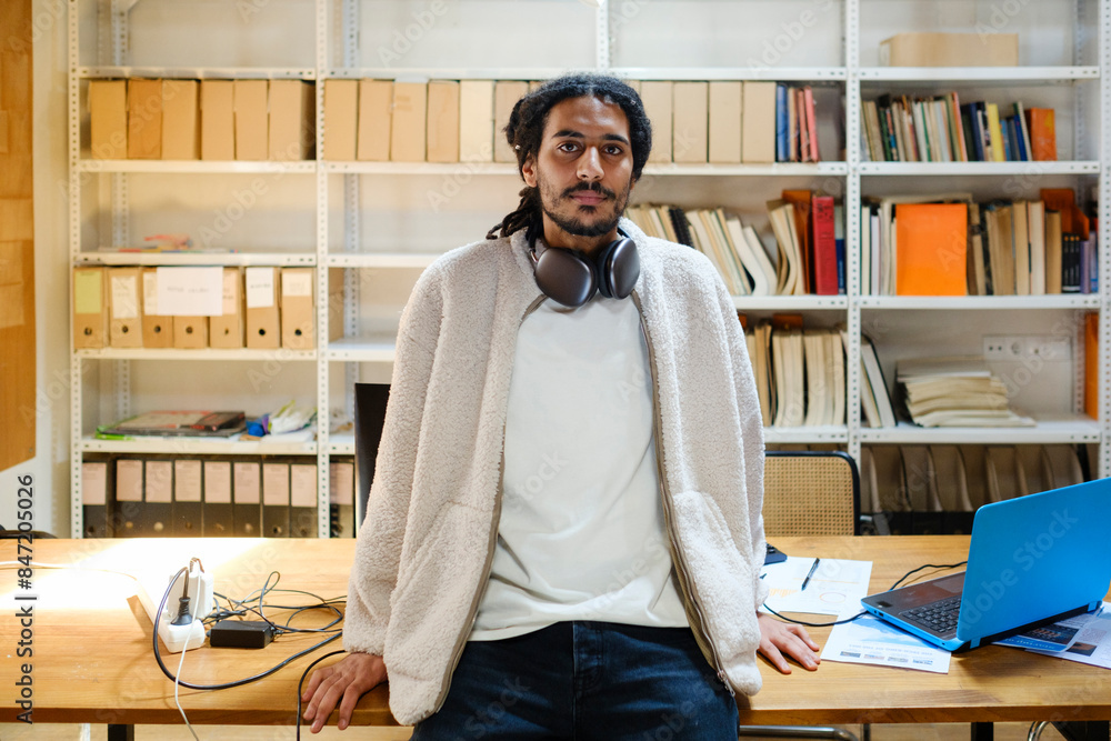 Portrait of young entrepreneur in startup messy office Stock Photo ...