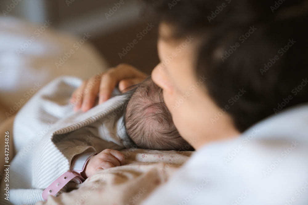 Newborn baby sleeping on her mother's chest Stock Photo | Adobe Stock