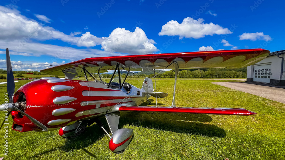 Old red airplane turboprop engine with propeller blades, parts of wings ...