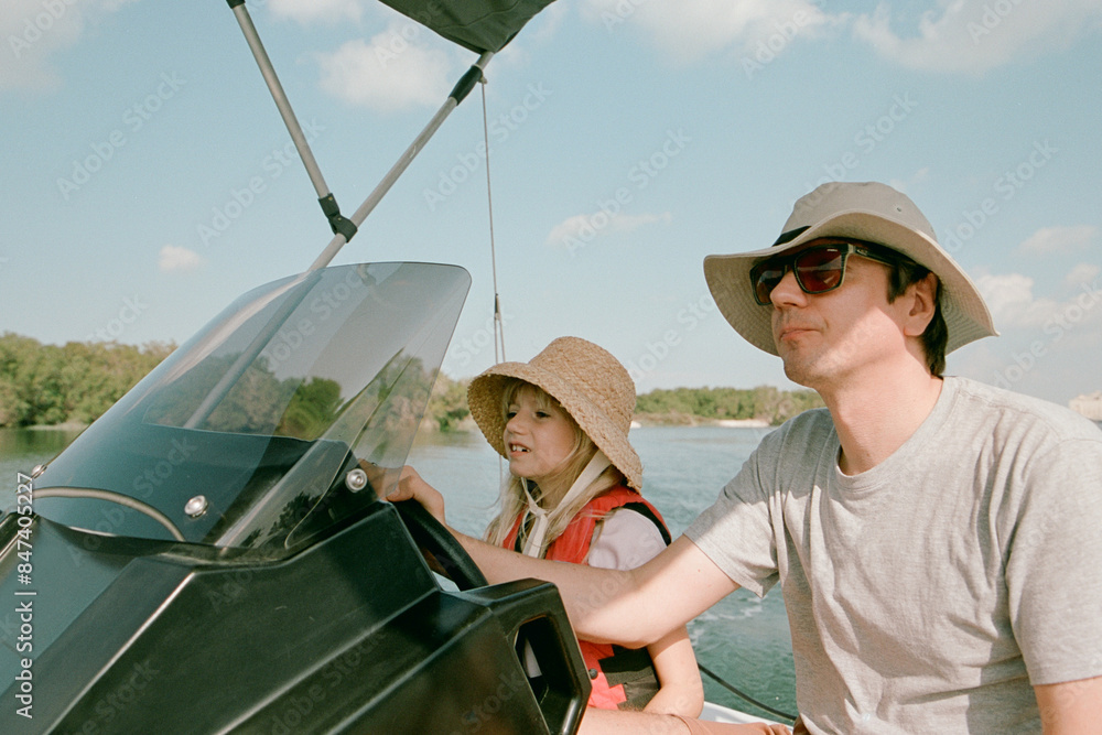 A girl with dad driving a boat in a mangrove forest in Abu Dhabi Stock ...