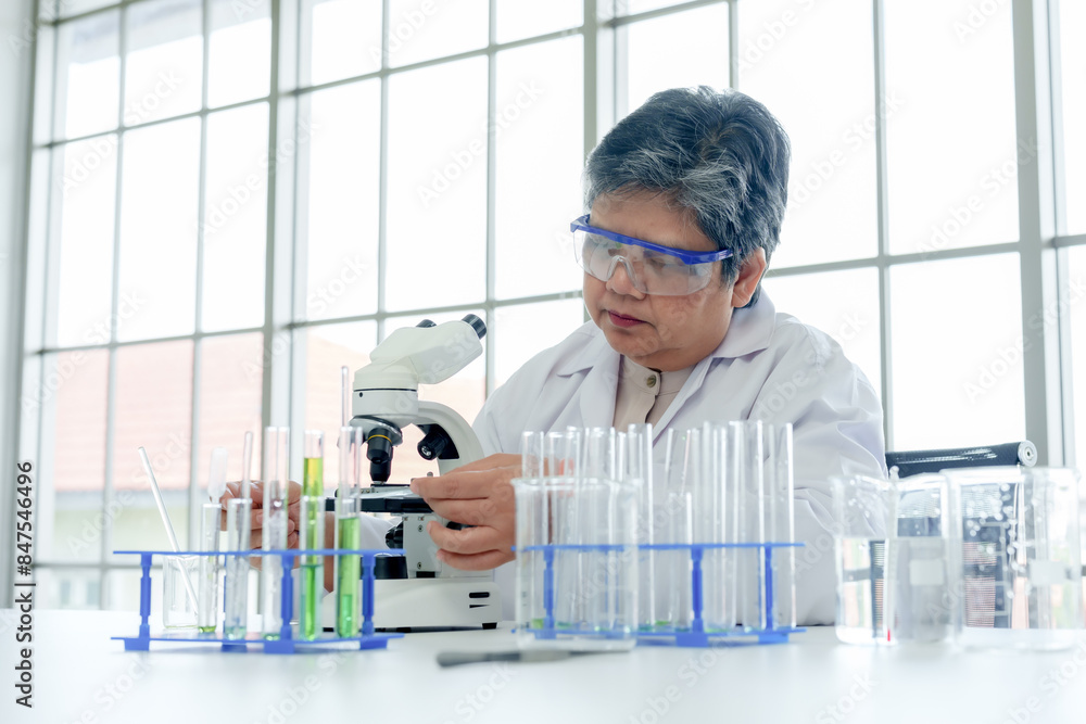 Senior Asian female science teacher, Older person in white lab coat ...