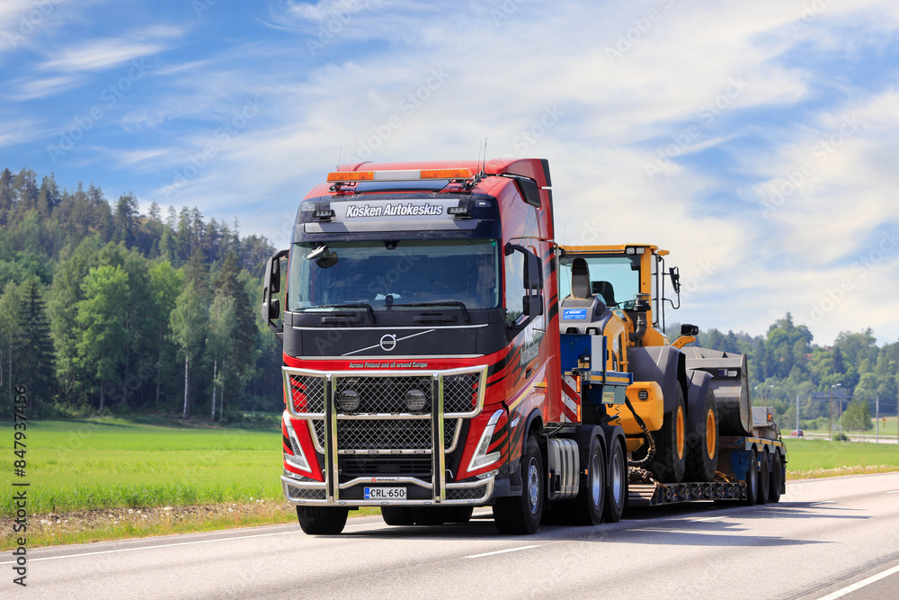 New Red Volvo FH truck transports Volvo wheel loader on low loader ...