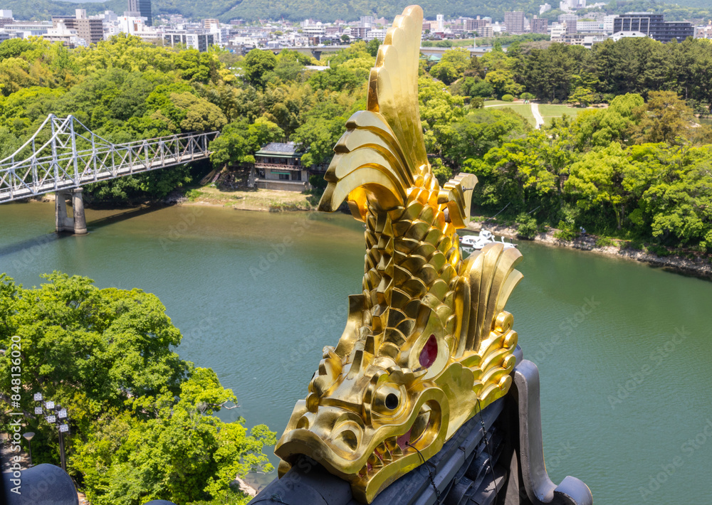 Golden dragon fish statue on roof top of Okayama castle, Japan Stock ...