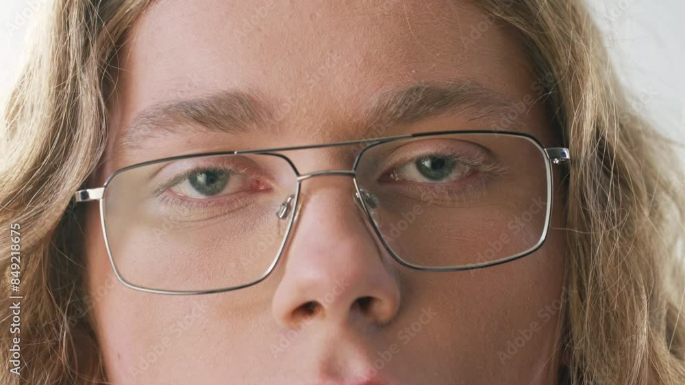 Close camera view of Caucasian mans face. Young guy with blonde curly ...