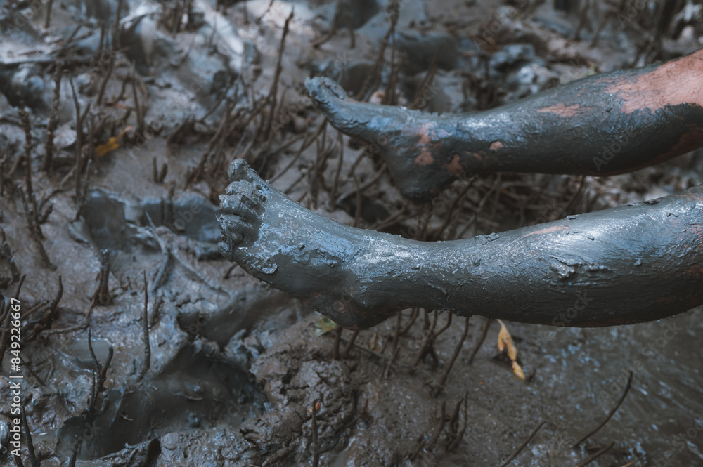 Feet and legs covered with mud It appears to be in a muddy, swamp-like ...