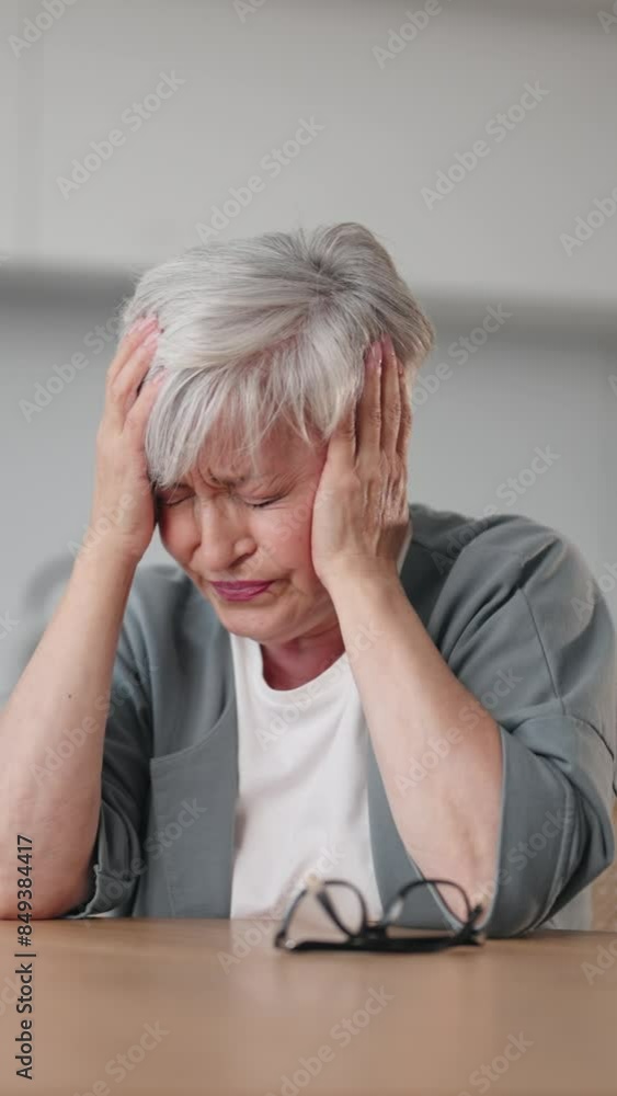 Old woman crying alone in home kitchen, vertical video with emotional ...