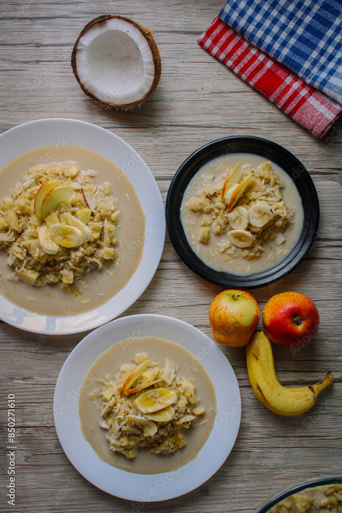 Poha(flatten rice) with milk and fruits (banana, apple, coconut). A ...