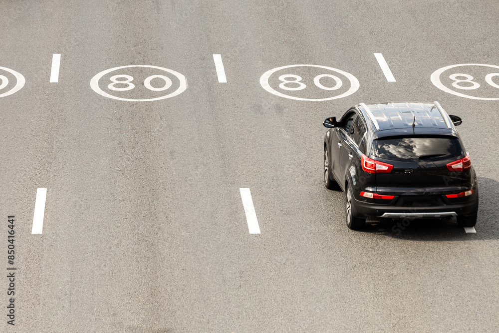 road markings indicating the recommended speed of 80 kilometers per ...