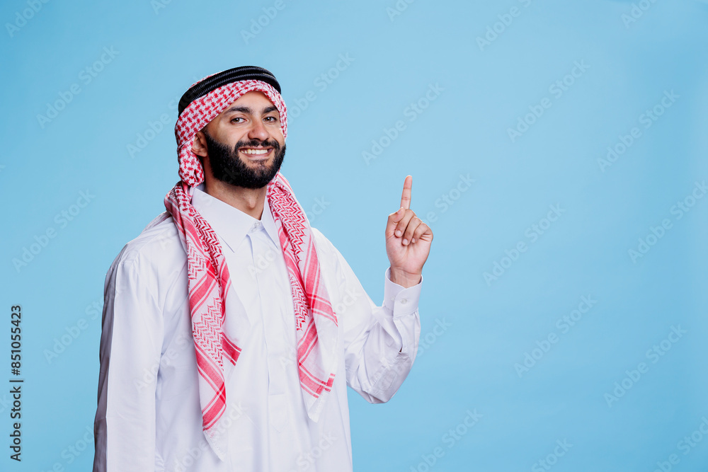 Smiling muslim man wearing traditional arabic clothes showcasing ...