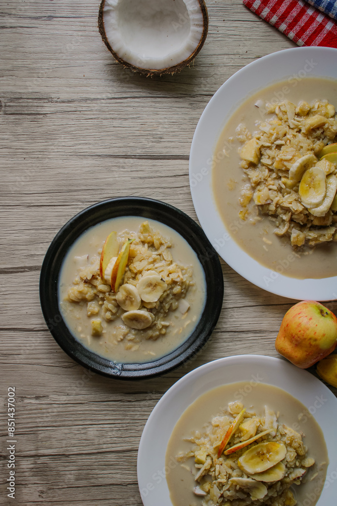Poha(flatten rice) with milk and fruits (banana, apple, coconut). A ...
