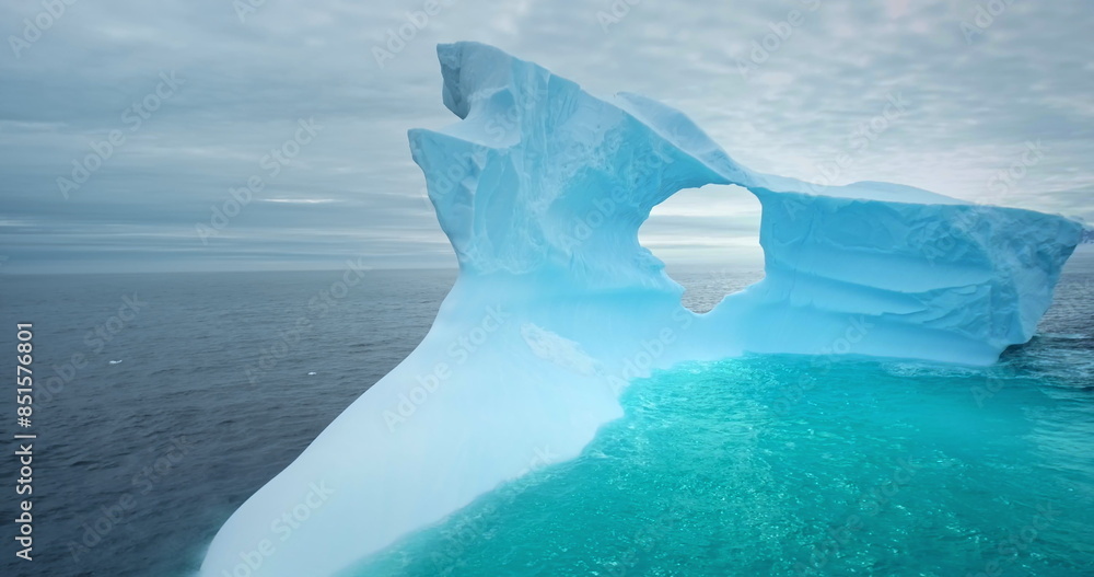 Large iceberg with melted hole floating arctic ocean. Big glacier ...