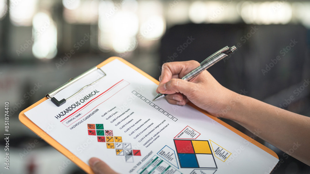 Action of a safety supervisor hand is checking on checklist of chemical ...