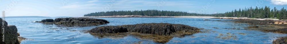 Panoramic low level view across tide pools at the oceanfront of ...