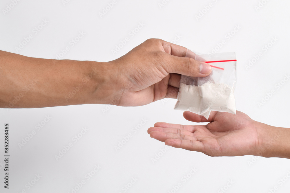 Hand giving cocaine in plastic package isolated on white background ...