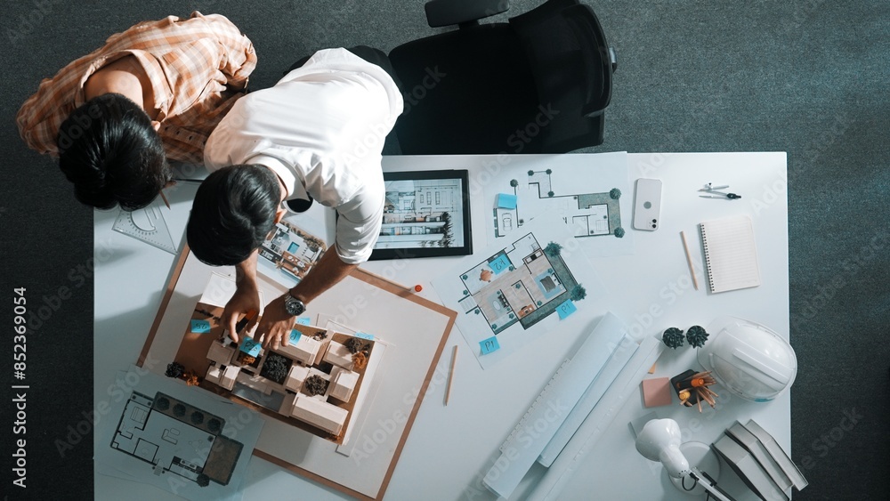 Top down view of skilled business man and colleague design house ...