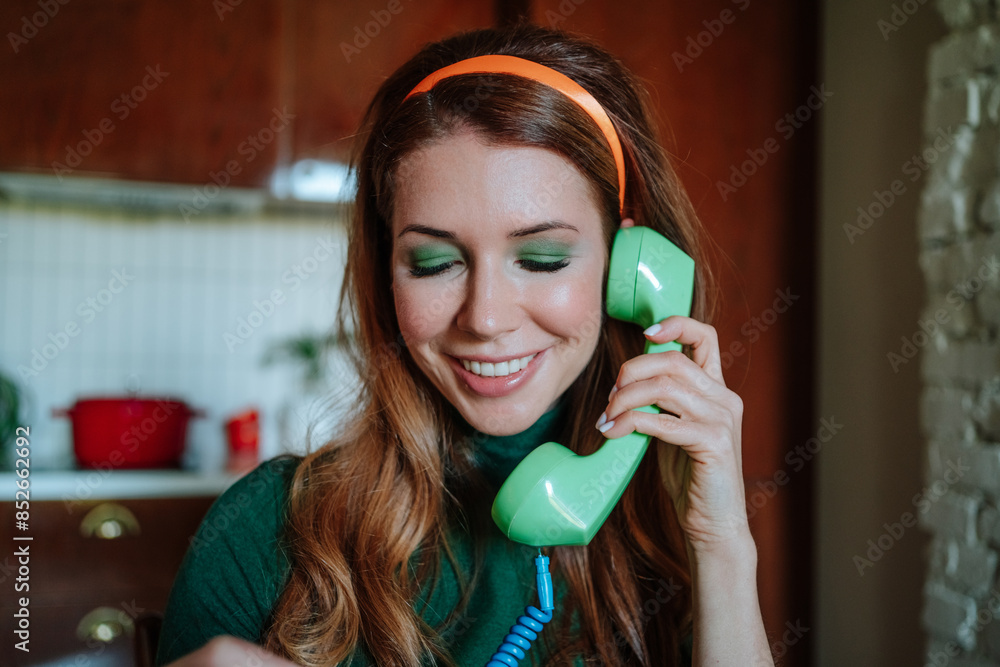 Woman in 1950s style using an old rotary phone and smiling Stock Photo ...