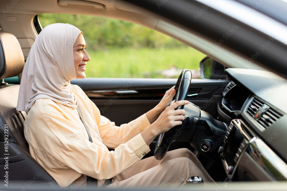 Muslim woman driving her luxury car, traveling, using automobile for ...