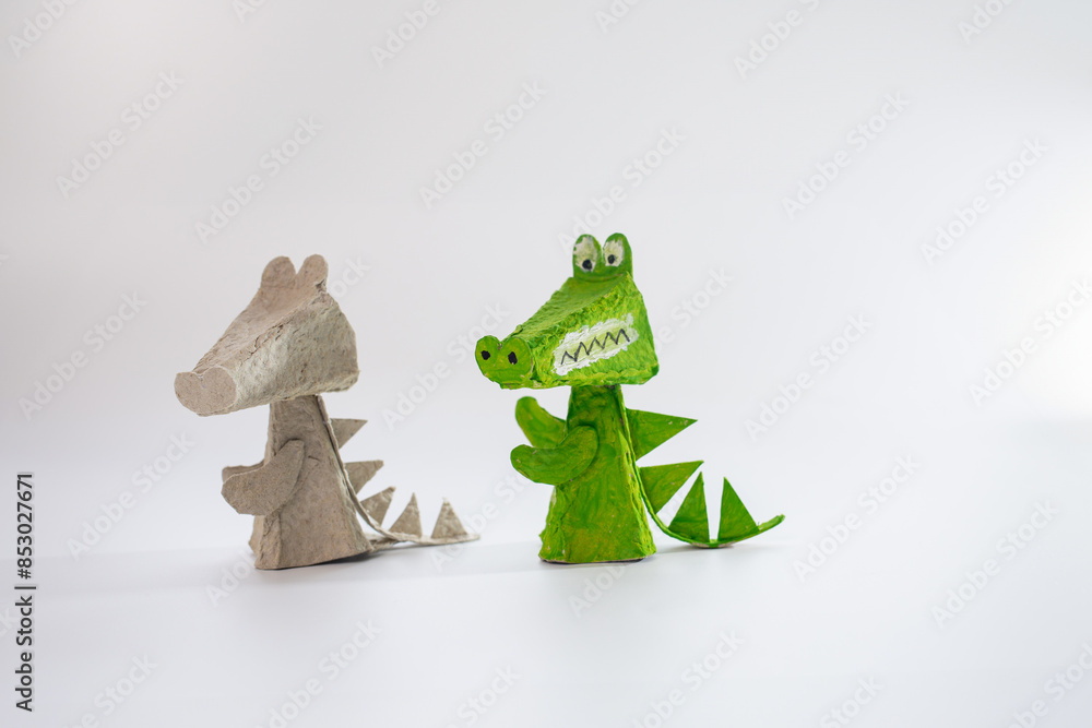 A couple of paper animals sitting next to each other in a recycling ...