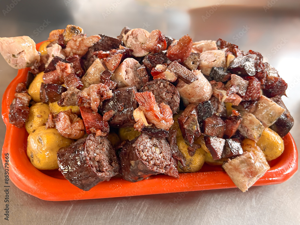 Picada is a typical Colombian plate made with beef, pork, potatoes and ...