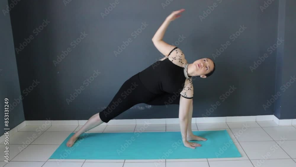 Female fitness instructor performing warrior posture. Utthita ...