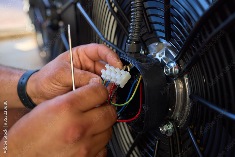 Electrician fixing complex wiring in junction boxes, showing expertise ...
