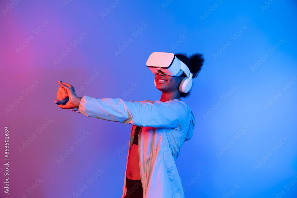 Young African woman playing game in basketball player wearing VR ...