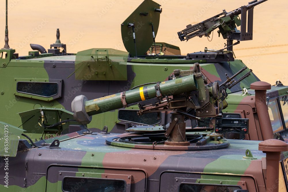 Military vehicle featuring a camouflage paint scheme, with a mounted ...