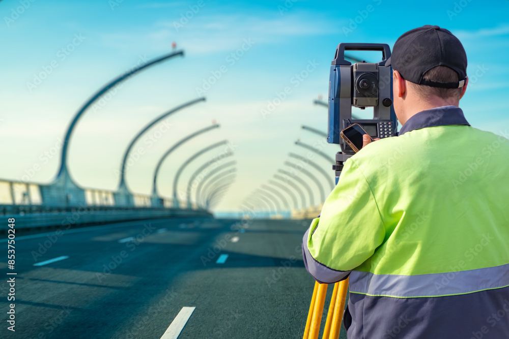 Man surveyor. Geodetic surveys during road construction. Surveyor ...