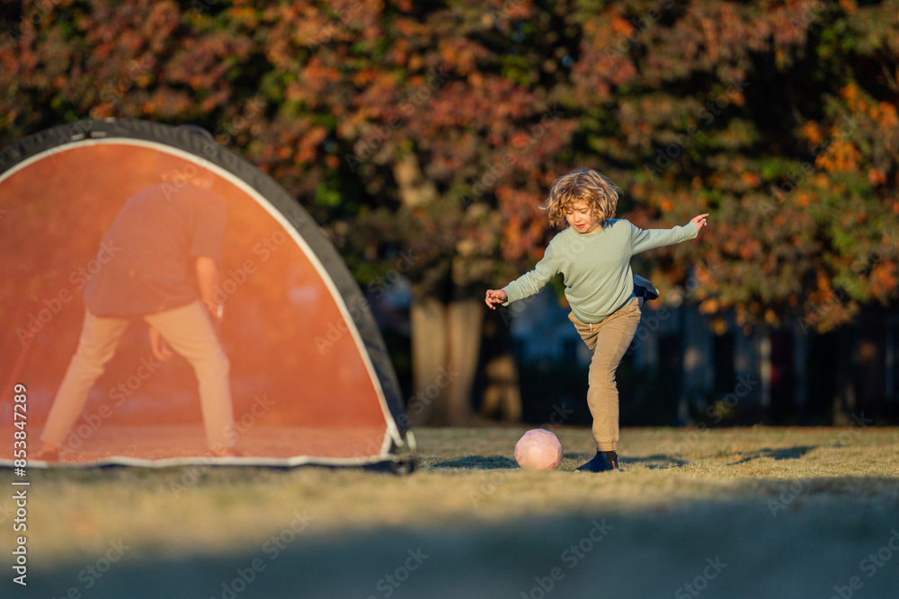 Kid Goalkeeper catches the ball in stadium during a football game ...