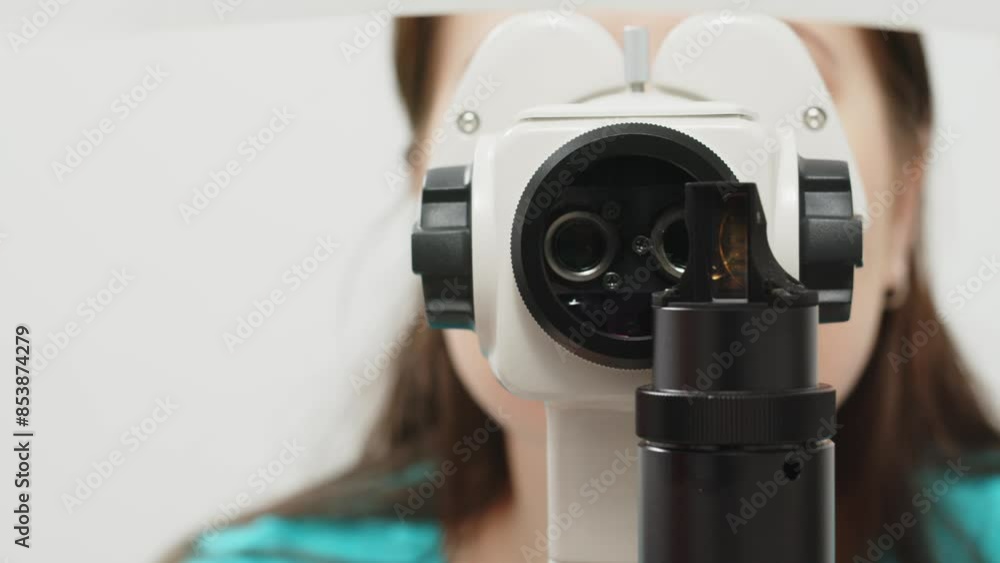 Examination of the child using a slit lamp. Microscope and focused ...