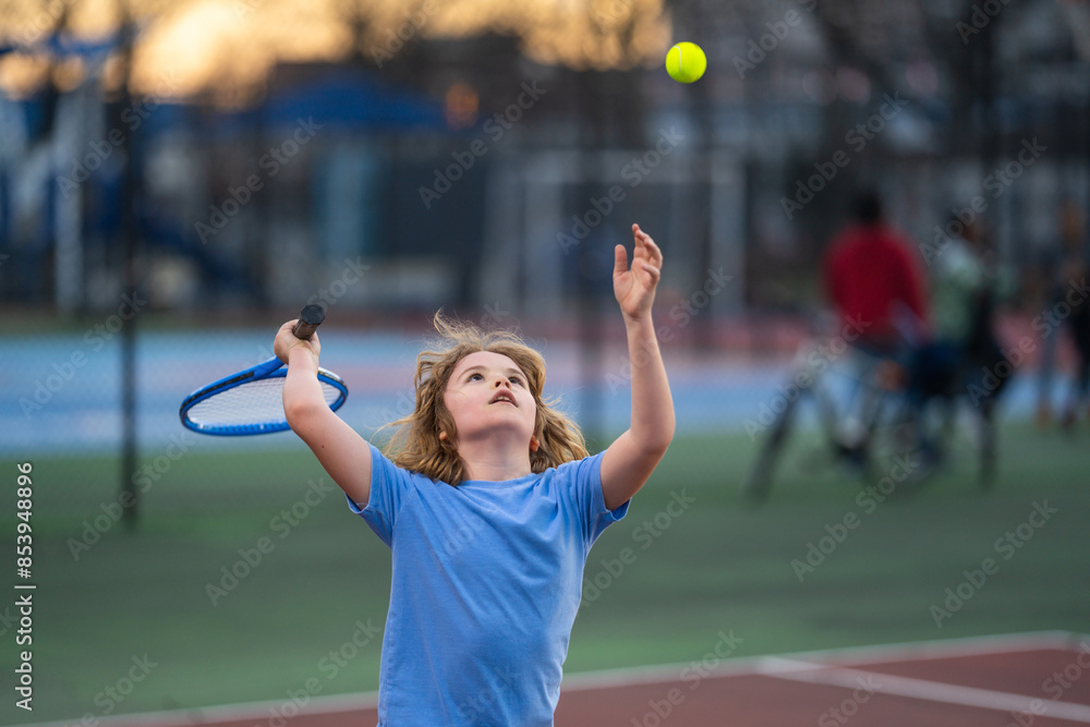 Kid playing tennis on court. Child hit tennis ball with tennis racket ...