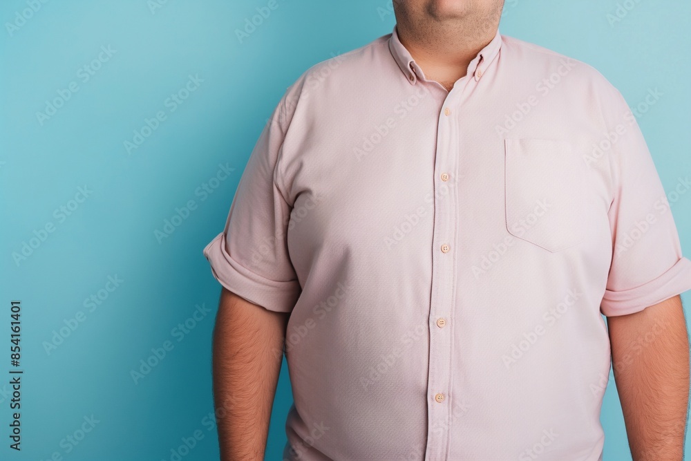 Overweight man in a tight shirt on a light blue background, Embracing ...