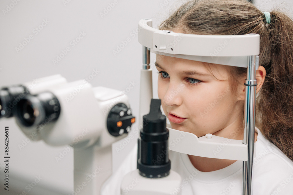 Examination of the child using a slit lamp. Microscope and focused ...