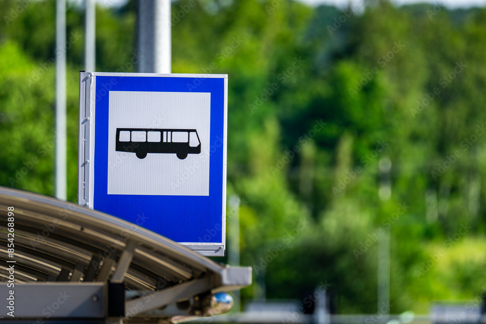 Blue Bus Stop Sign With Bus Icon and Green Trees in Background Stock ...