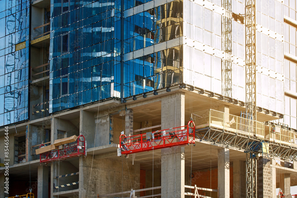 Suspended platform on building facade. Insulation facade walls and ...