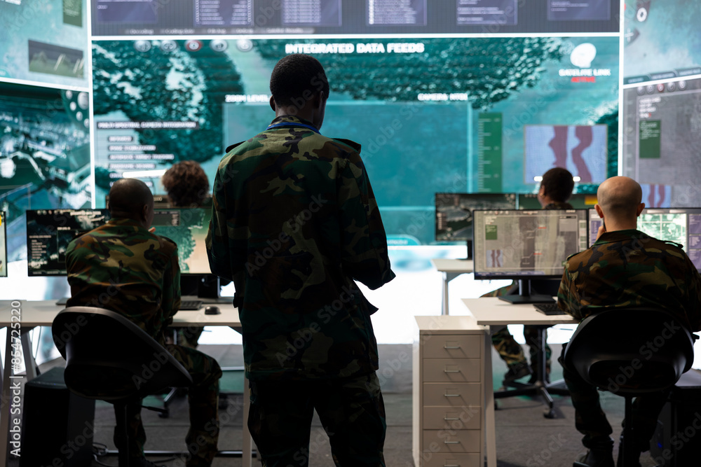 Infantry unit trooper analyzing intelligence gathered from satellite ...