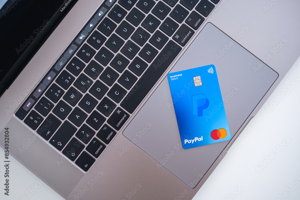 Blue PayPal Business Debit Card with Mastercard Logo Placed on Laptop ...