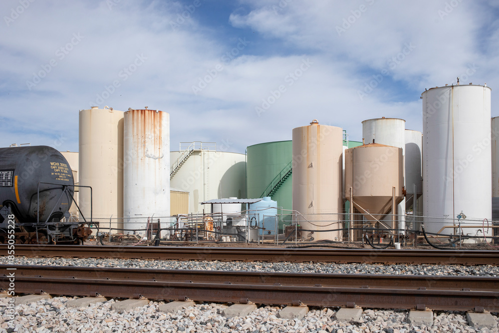 Chemical storage tanks along railroad tracks Stock Photo | Adobe Stock